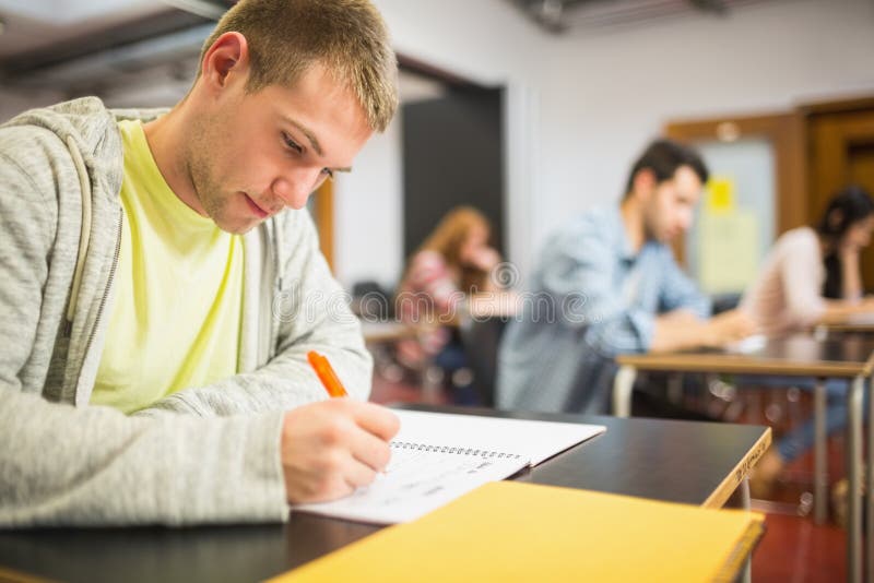 Students Writing Notes in Classroom Stock Photo - Image of classroom ...