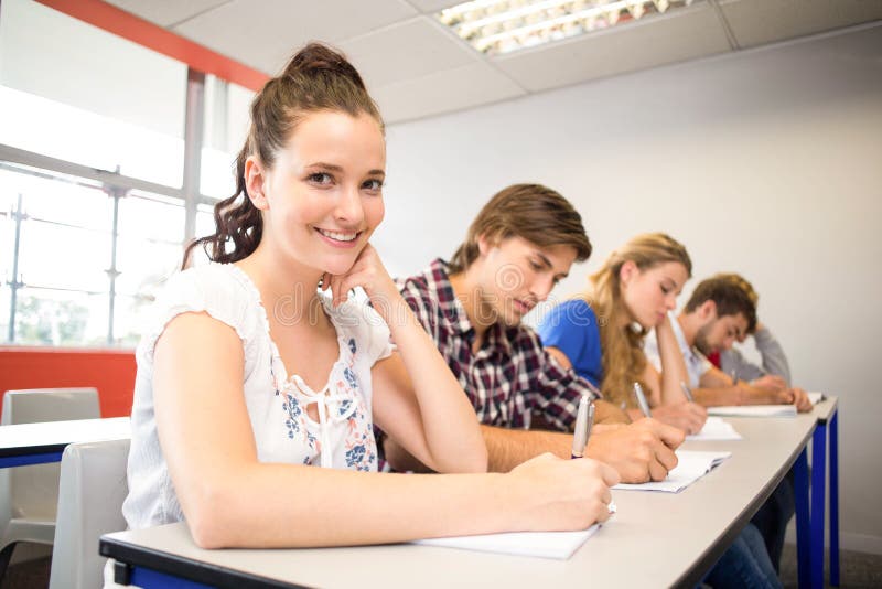 Students Writing Notes in Classroom Stock Image - Image of school ...