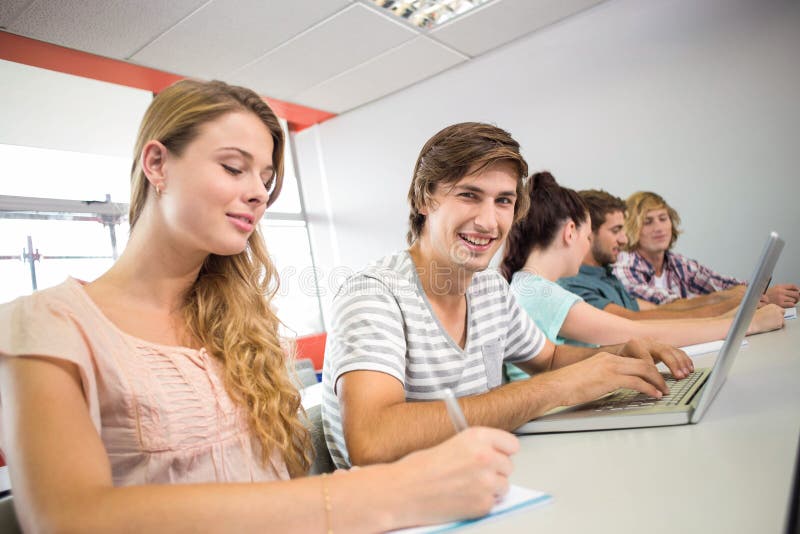 Students Writing Notes in Classroom Stock Image - Image of cooperation ...