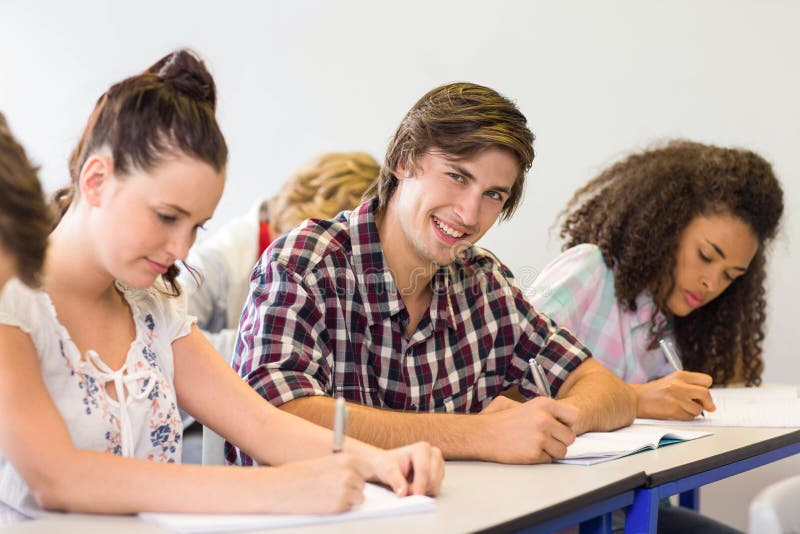 Students Writing Notes in Classroom Stock Photo - Image of classroom ...