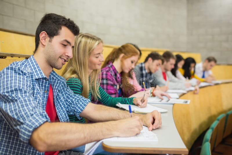Students Writing Notes in a Row at Lecture Hall Stock Photo - Image of ...