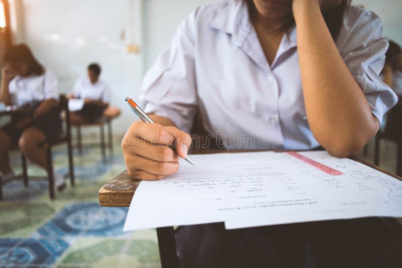 Students Writing Pen in Hand Doing Exams Answer Sheets Exercises in ...