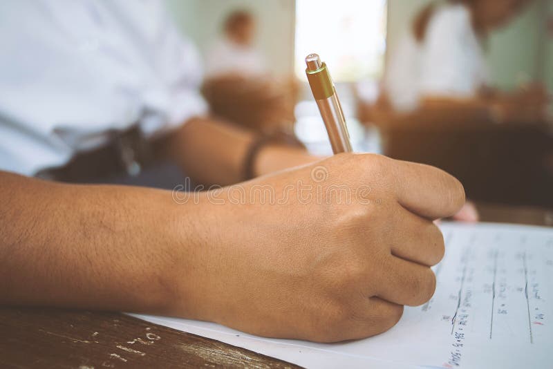 Students Writing Pen in Hand Doing Exams Answer Sheets Exercises in ...