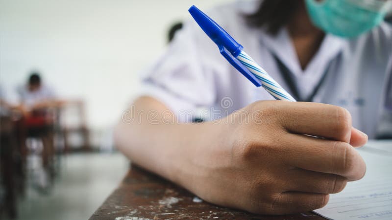 Students Writing Pen in Hand Doing Exams Answer Sheets Exercises in ...