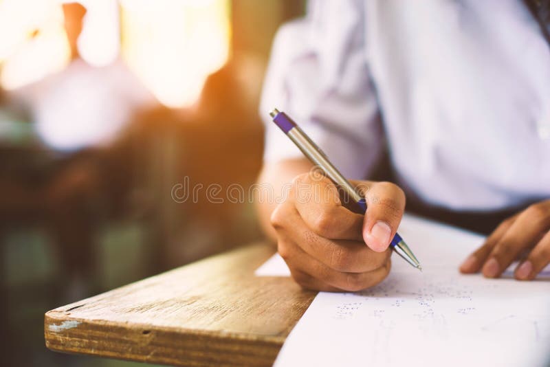 Students Writing Pen in Hand Doing Exams Answer Sheets Exercises in ...