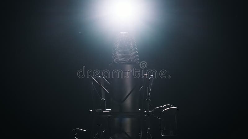 The Studio Condenser Microphone in Backlight Rotates on a Black ...