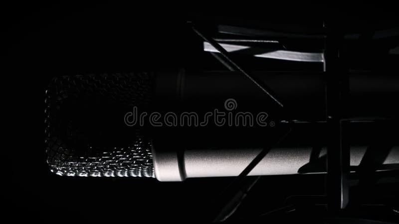The Studio Condenser Microphone in Backlight Rotates on a Black ...