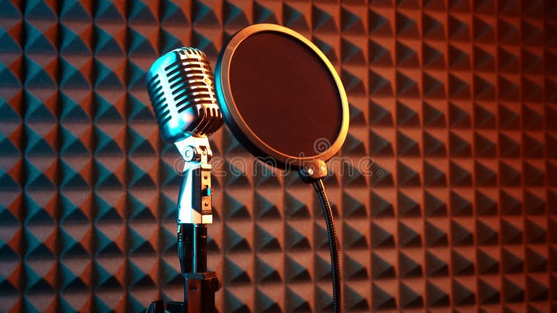 Condenser Microphone with a Large Golden Diaphragm on a Dark Background ...