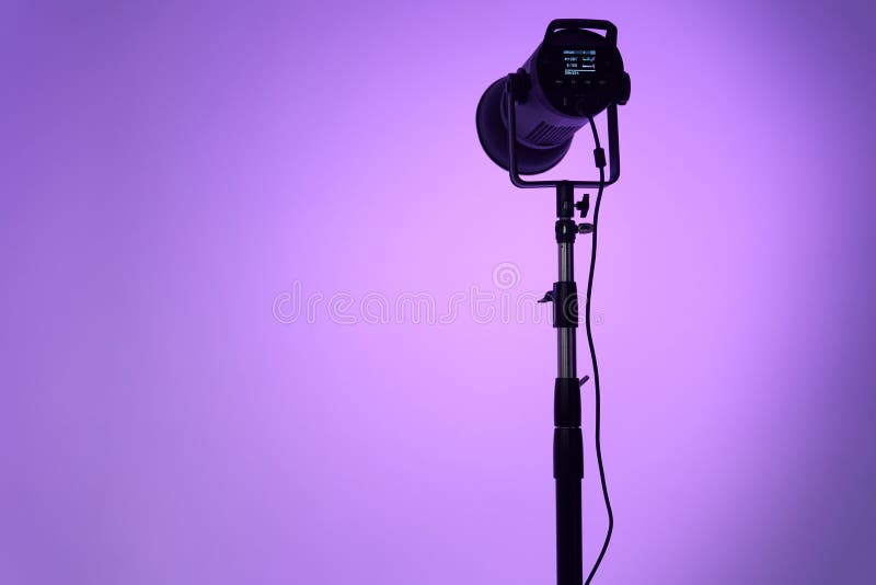 Studio Flash on a Tripod Against a Background of Colored Light. Pulsed ...