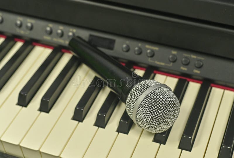 Studio Microphone on Electronic Piano Keys, Symbolizing Music ...