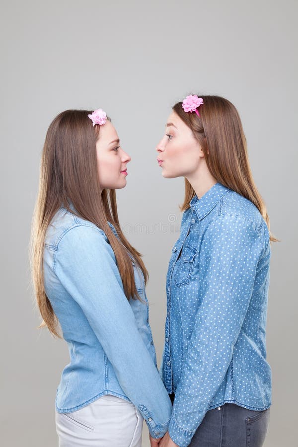 Studio Portait of Young Twin Sisters Fighting Stock Photo - Image of ...