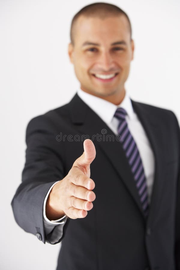 Studio Portrait of Businessman Reaching Out To Shake Hands Stock Image ...