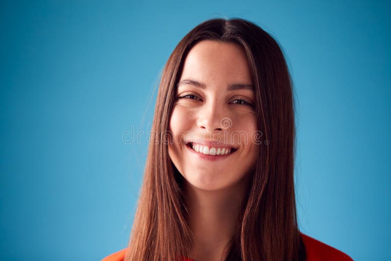 Studio Portrait of Confident Young Woman Looking into Camera Against ...
