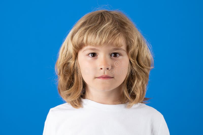 Studio Portrait of Cute Kid Looking Forward on Blue Isolated Background ...