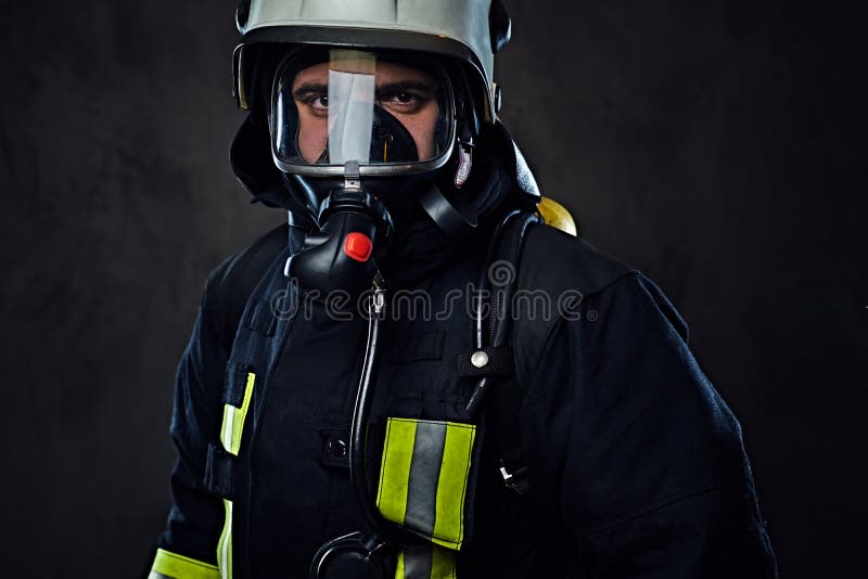 Firefighter Dressed in Uniform and an Oxygen Mask. Stock Photo - Image ...