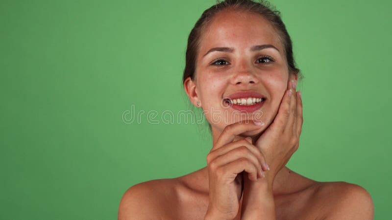 Gorgeous Happy Woman Touching Her Face Gently Smiling To The Camera
