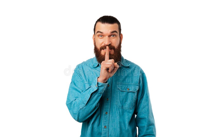 Studio Portrait of a Handsome Bearded Man Holding His Finger Over the ...