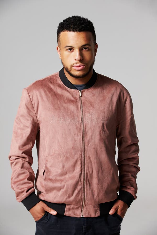 Studio Portrait of Man Standing Against Grey Background Stock Photo ...