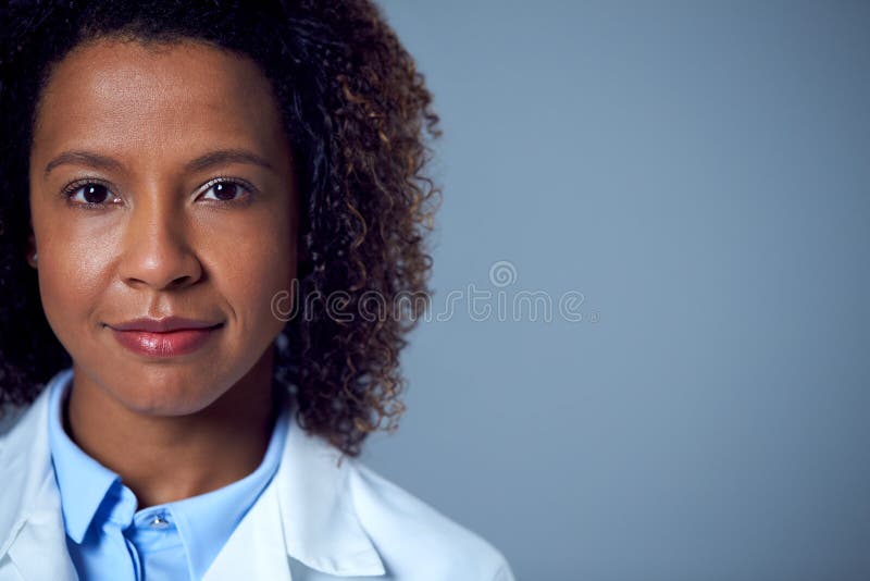 Studio Portrait of Smiling Female Doctor or Lab Worker in White Coat ...