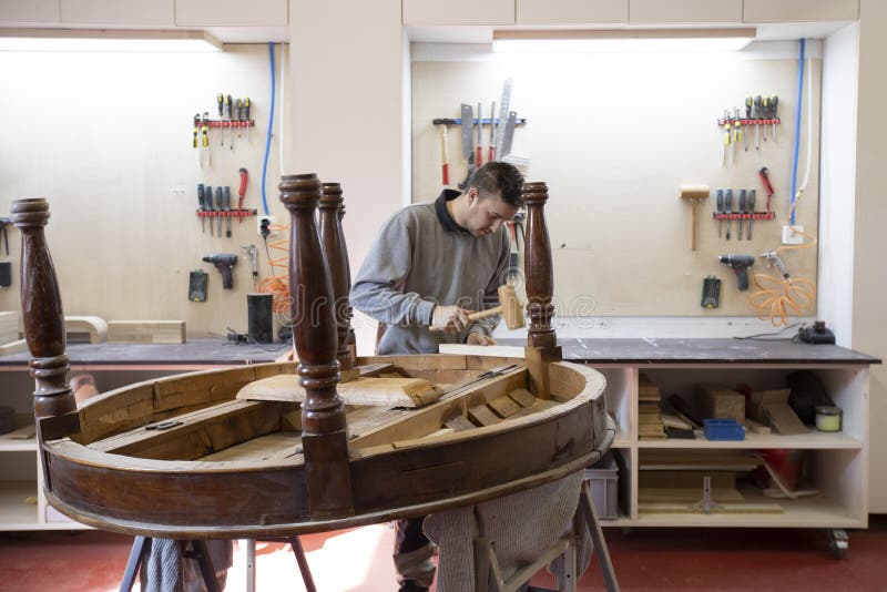 Young Carpenter Man Looking and Choosing Wood Plank at Workshop in ...