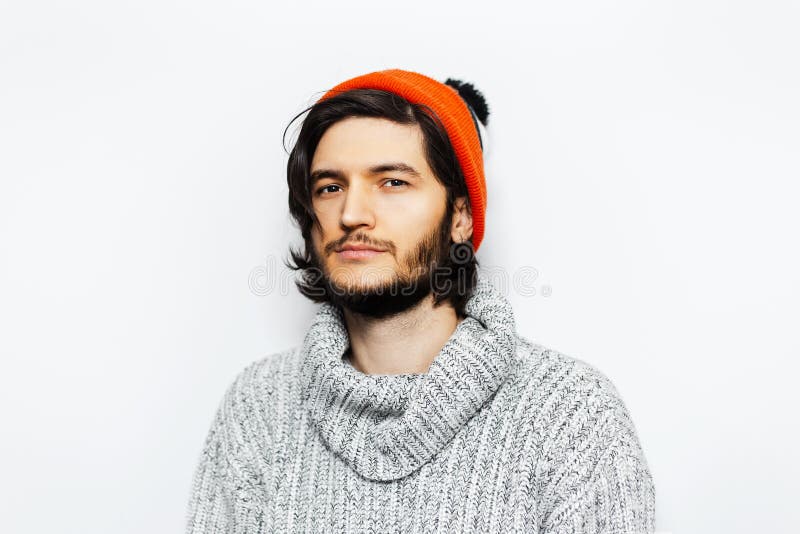 Studio Portrait of Young Guy with Orange Hat and Grey Sweater on White ...