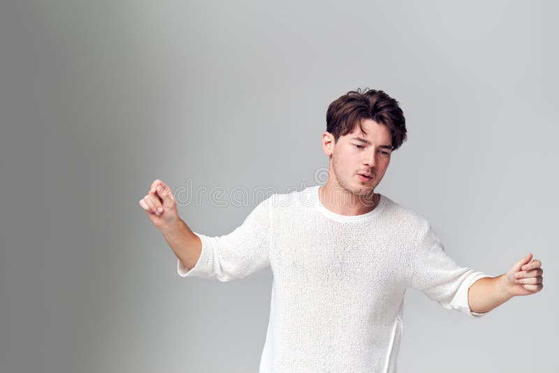 Studio Portrait of Young Man Having Fun Dancing To Camera Stock Image ...