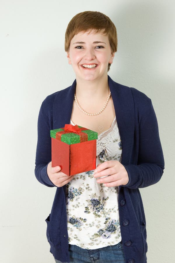 Studio Portrait of Young Woman Holding Gift Box Stock Photo - Image of ...