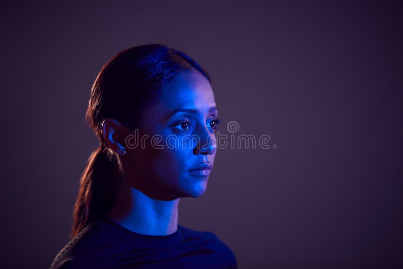Studio Profile Shot of Woman with Face Illuminated by Blue Light Stock ...