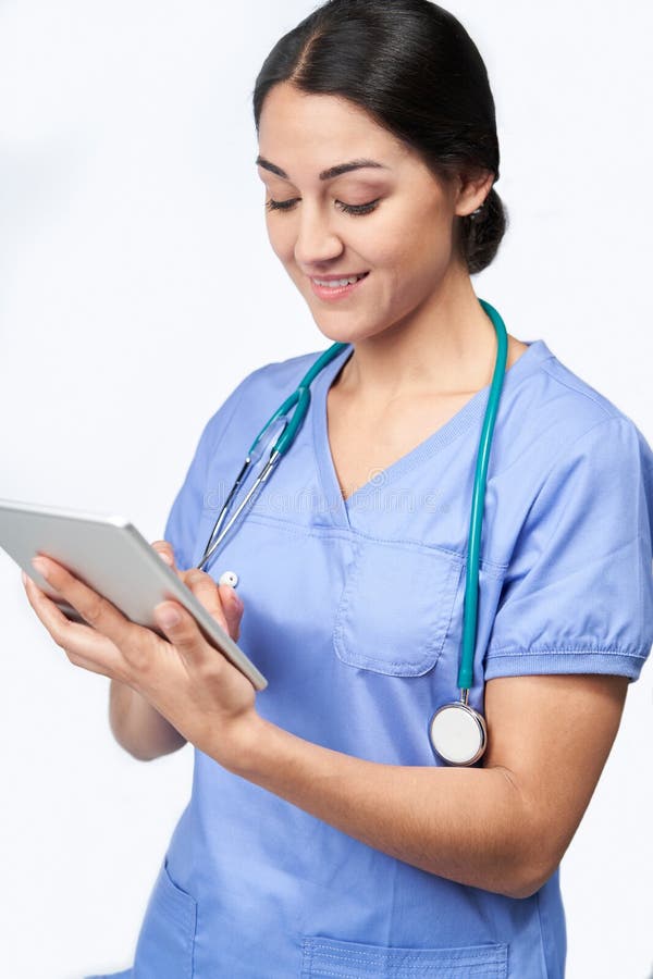 Studio Portrait Shot of Female Nurse Wearing Scrubs Using Digital ...