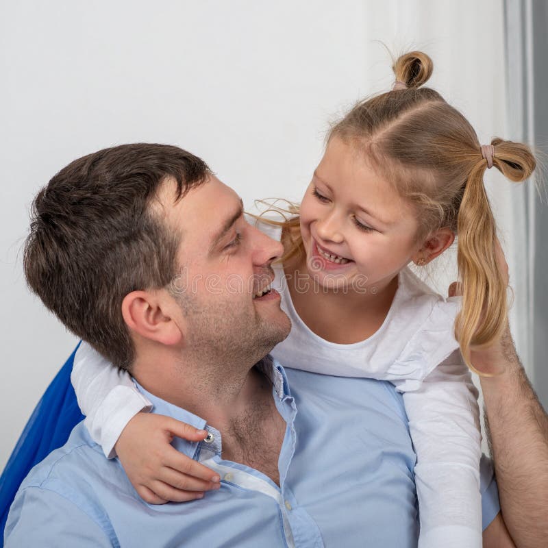 Studio Shot of a Daughter Hugging Her Father with a Happy Expression ...