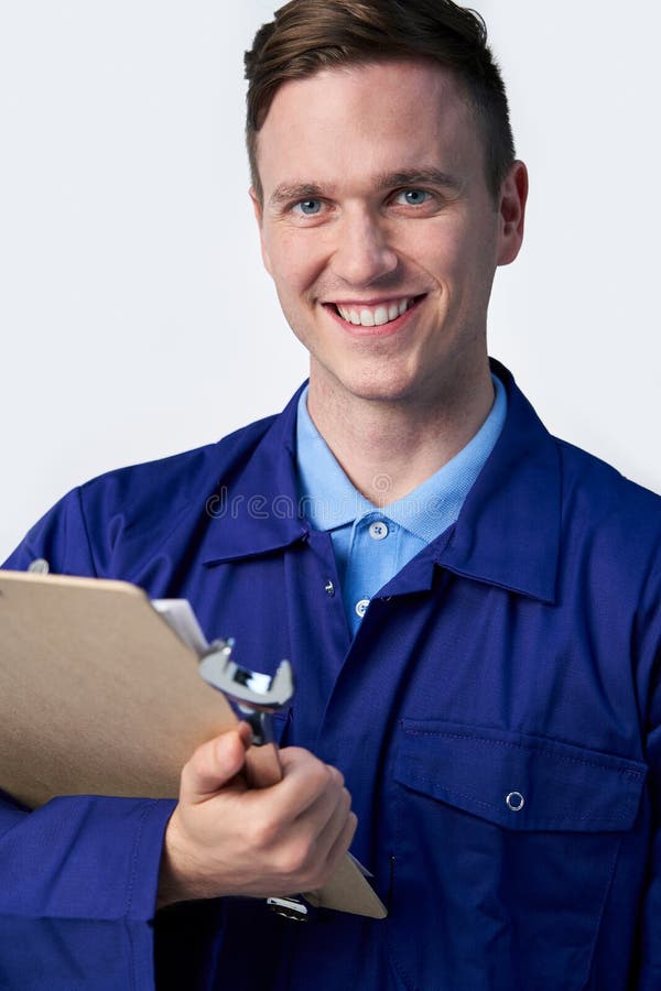 Studio Shot of Male Engineer with Clipboard and Spanner Against White ...