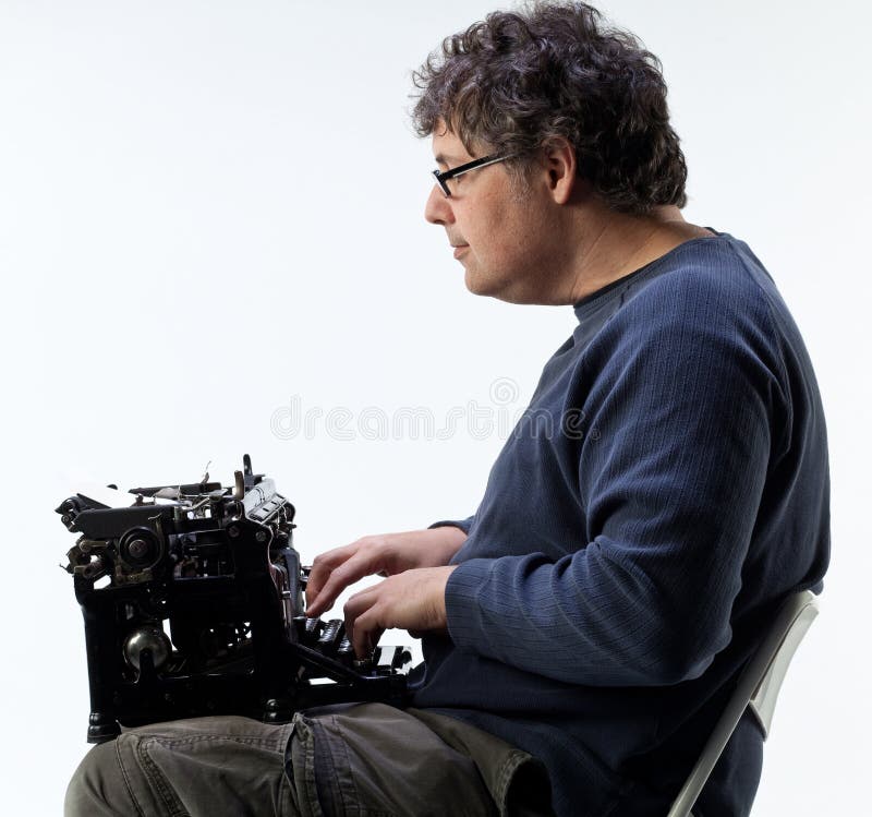 Studio Shot of a Man Typing with the Typewriter on His Lap Stock Photo ...