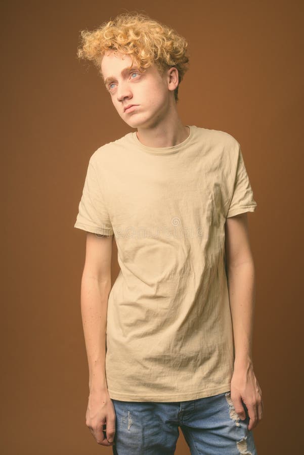 Skinny Young Man With Curly Hair Against Brown Background Stock Image ... Skinny Young Man With Curly Hair Against Brown Background Stock Image ...