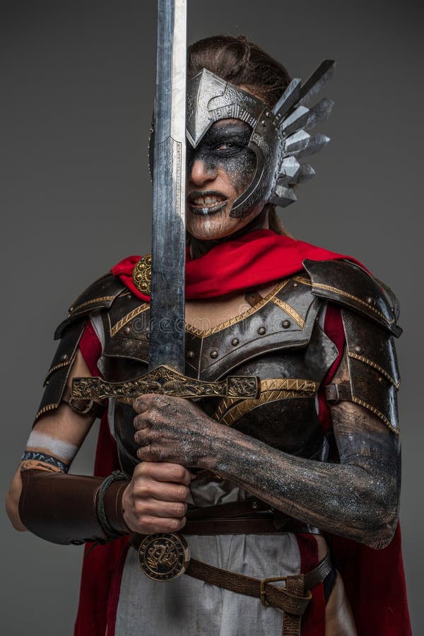Angry Female Warrior with Sword Aganst Grey Background Stock Photo ...