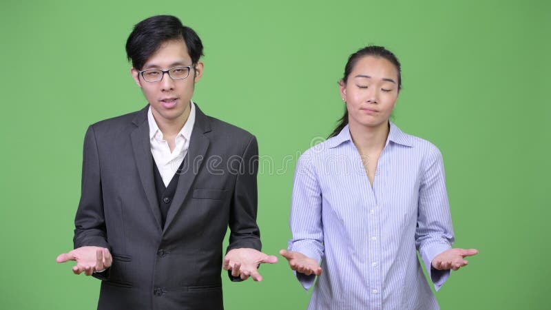 Young Asian Business Couple Shrugging Together Stock Footage - Video of ... Young Asian Business Couple Shrugging Together Stock Footage - Video of ...