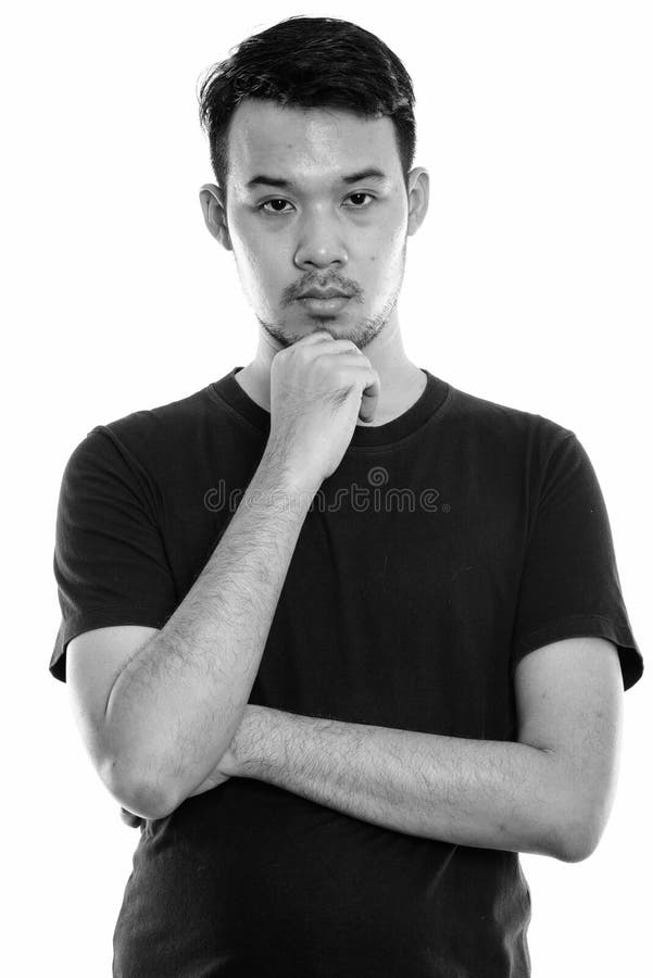 Studio Shot of Young Asian Man Thinking Stock Photo - Image of looking ...
