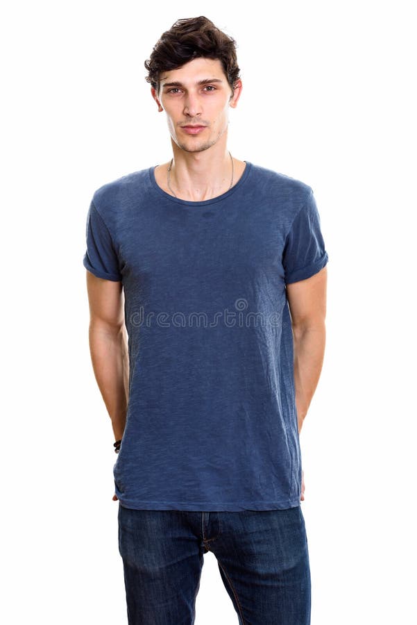 Studio Shot of Young Handsome Man Standing with Hands on Back Po Stock ...