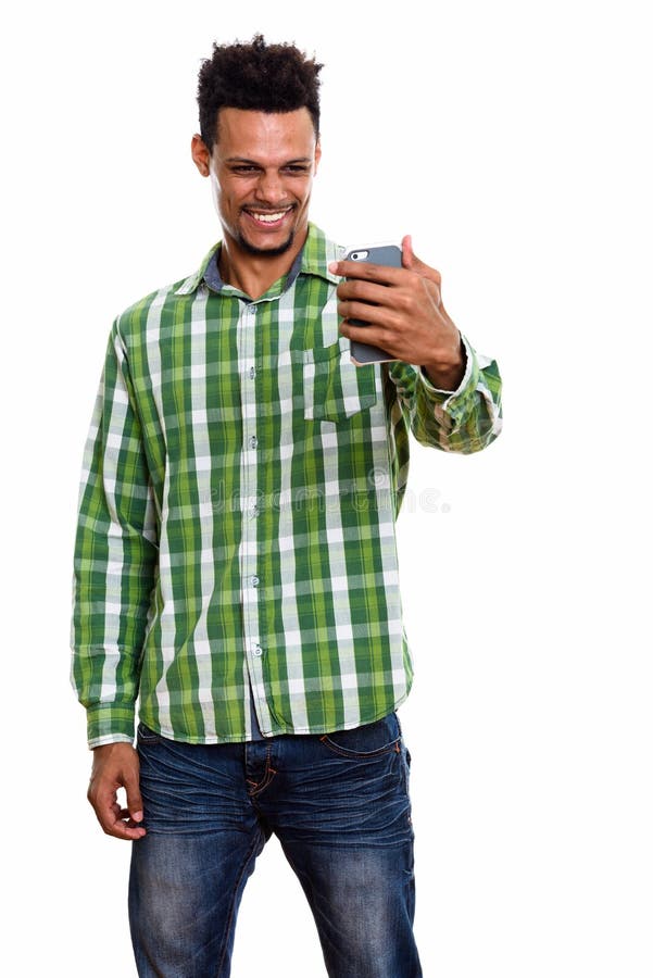 Studio Shot of Young Happy African Man Smiling while Holding Mob Stock ...