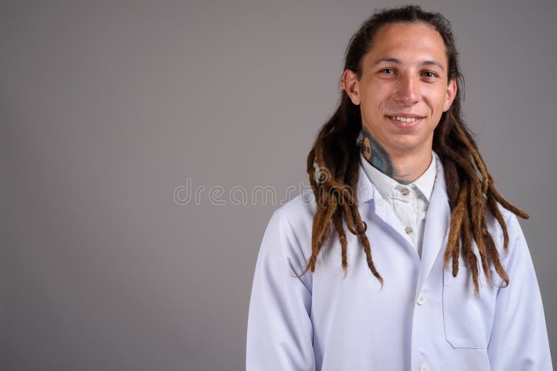 Young Man Doctor with Dreadlocks Against Gray Background Stock Photo ...