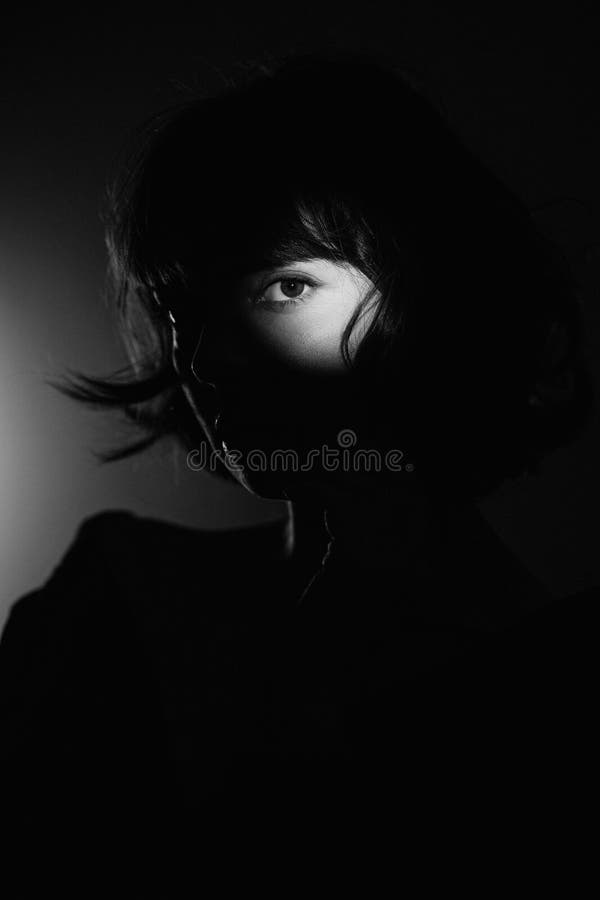 Studio Shot of a Young Woman in a Ray of Light. Stock Image - Image of ...
