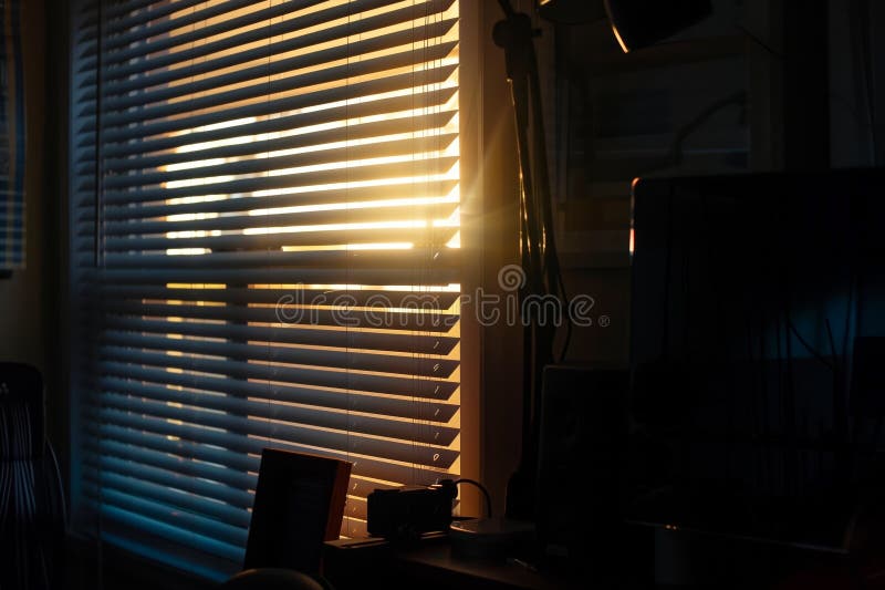 Studio at Twilight with Light Peeking through Blinds Stock Photo ...