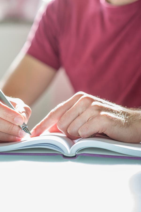 Studious Man Writing on His Notebook on the Table. Stock Photo - Image ...