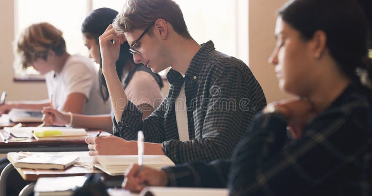 Study Hard, Make a Difference. Teenagers Writing an Exam in a Classroom ...