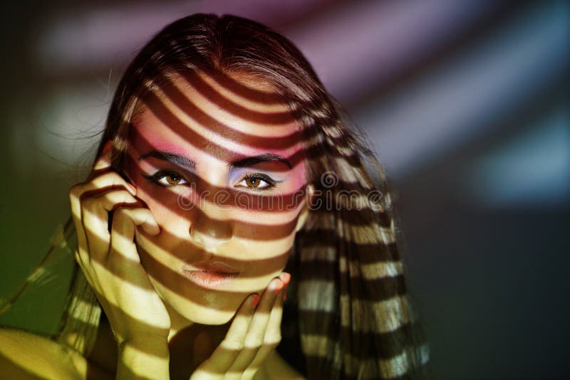 Study of Light,shadow and Beauty. Studio Shot of a Young Woman with ...