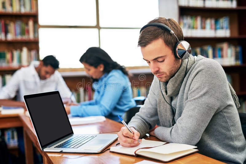 In the Study Zone. a University Student Working in the Library at ...