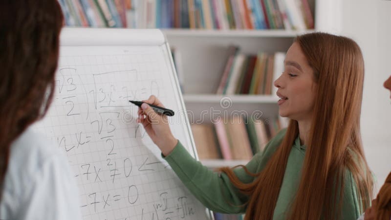 Group of Young Female Students Solving Equation Together at Classroom ...
