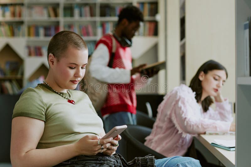 Studying in Library with Smartphones and Books Stock Photo - Image of ...
