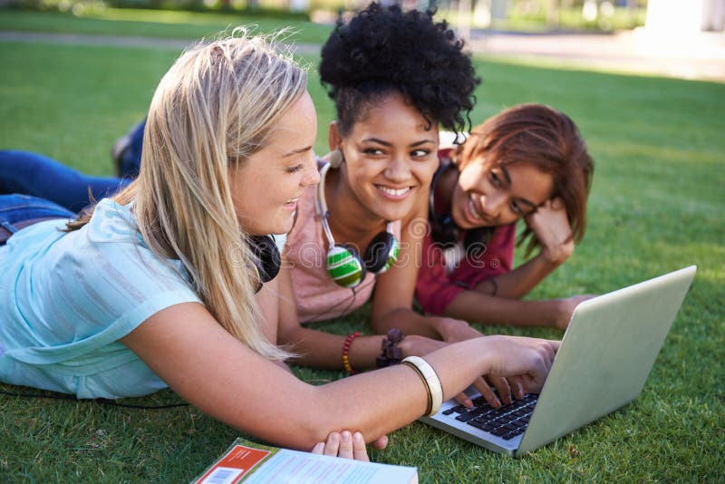 Studying Made Fun. Three Young Students Lying on the Grass in a Park ...