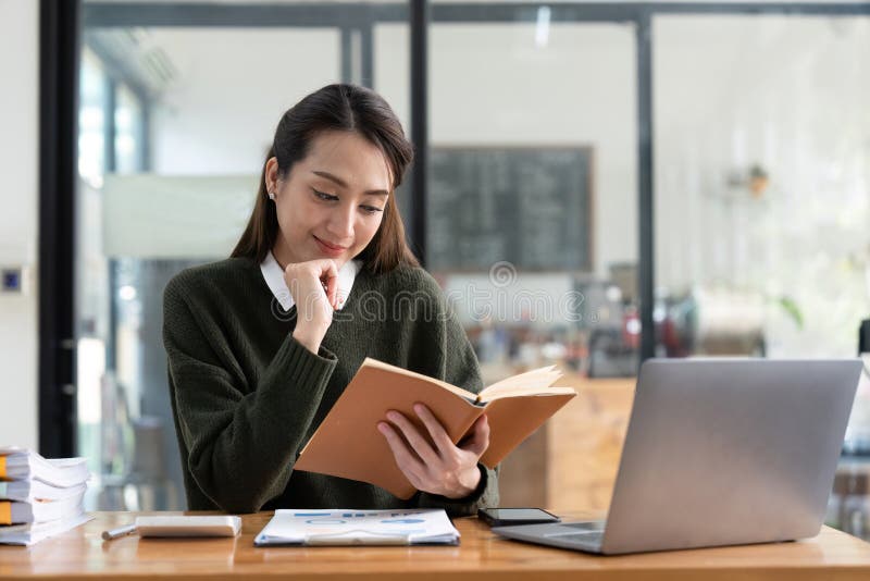 Studying Remotely from Home, Using a Laptop, Taking Notes on Notepad ...