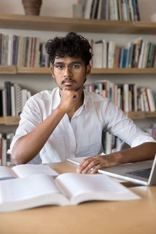 Portrait Confident Male Student Sitting at Work Table in Library Stock Image - Image of ...